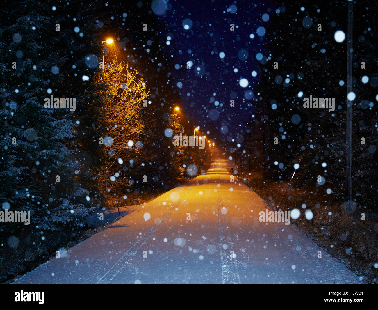 Illuminated road at winter Stock Photo - Alamy