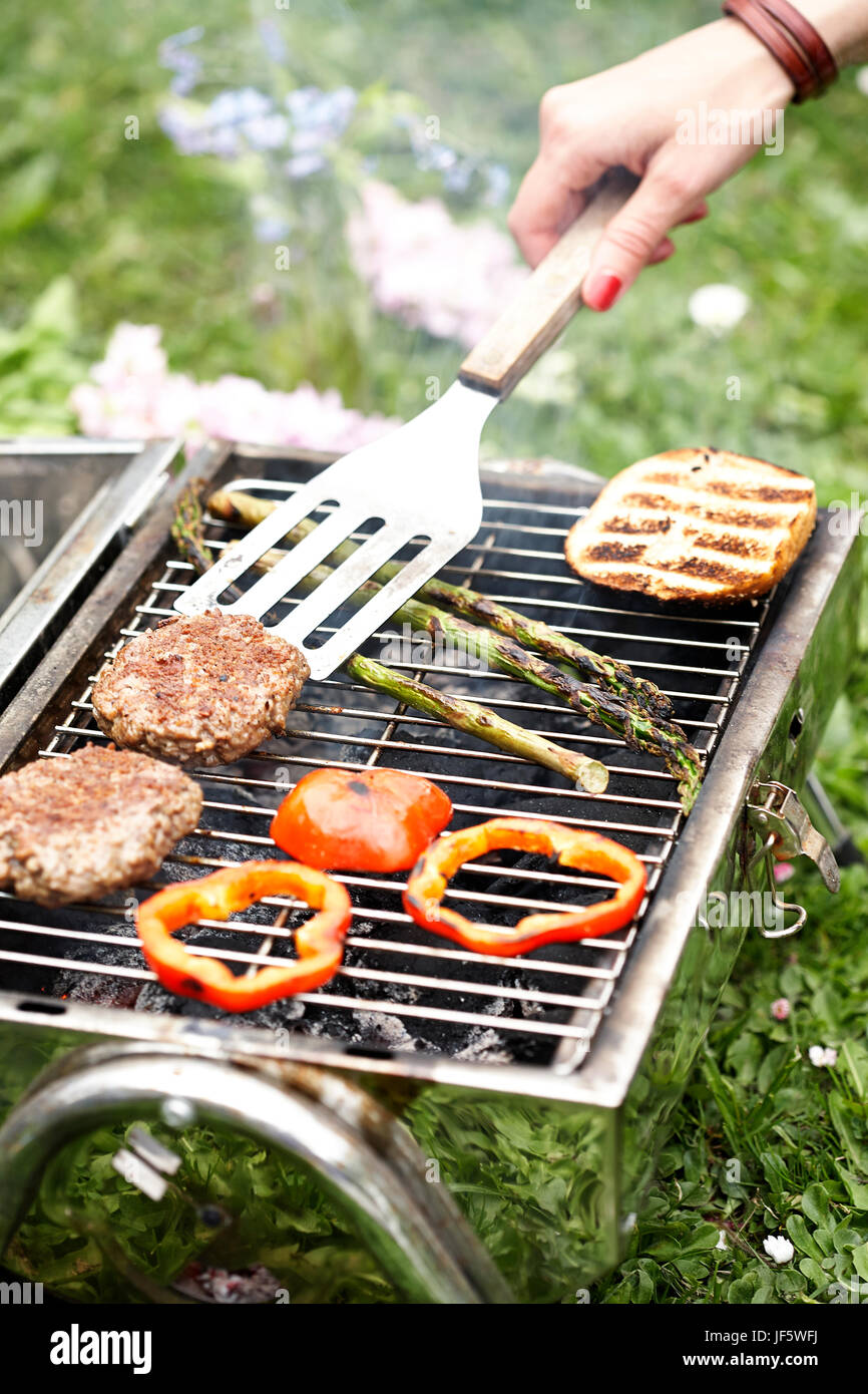 Preparing food on grill Stock Photo - Alamy