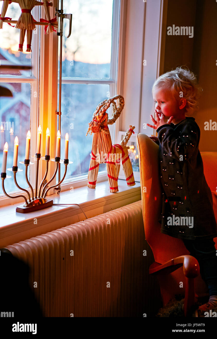 Girl looking through window Stock Photo - Alamy