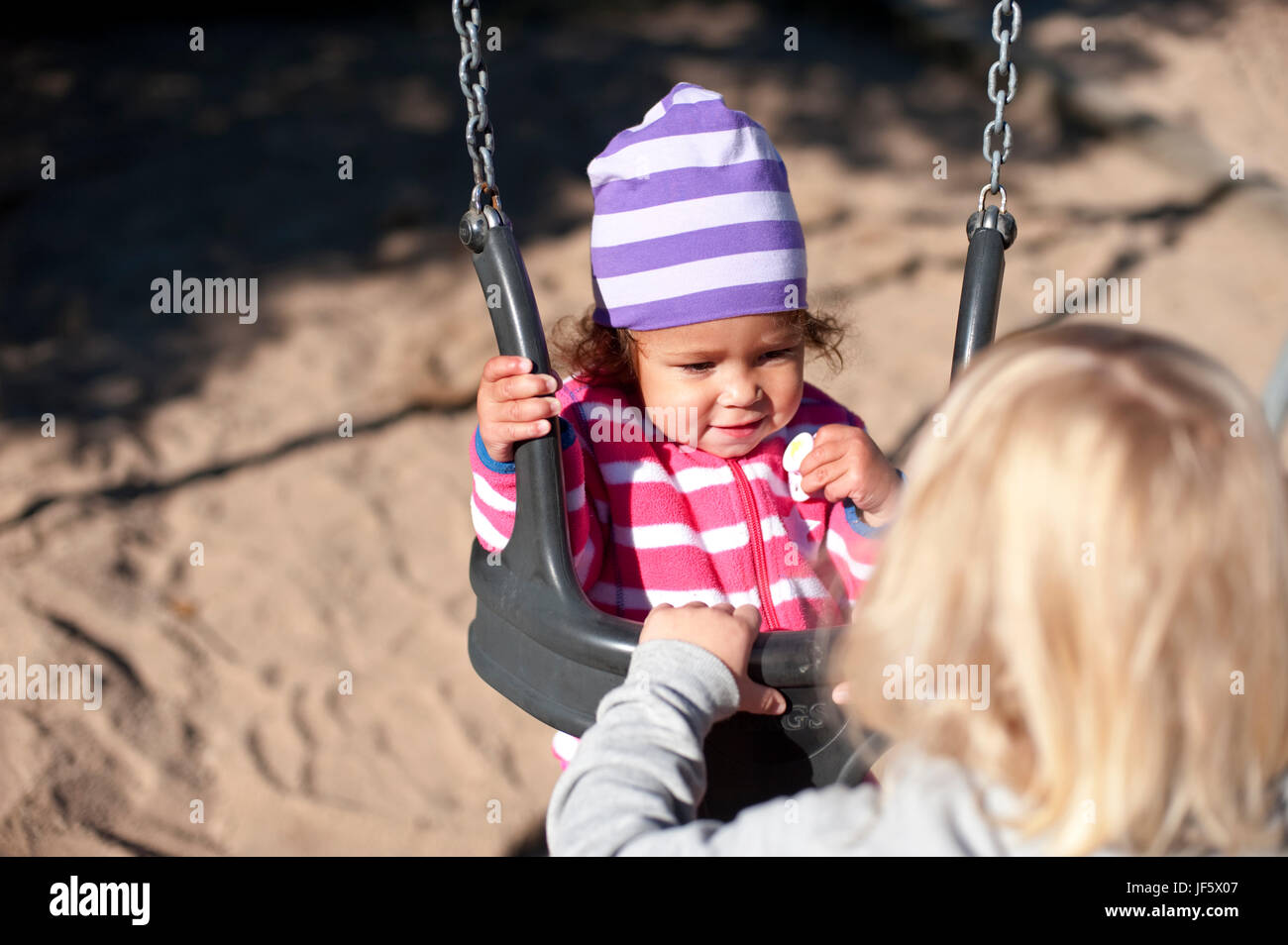 Two girls playing sand hi-res stock photography and images - Alamy
