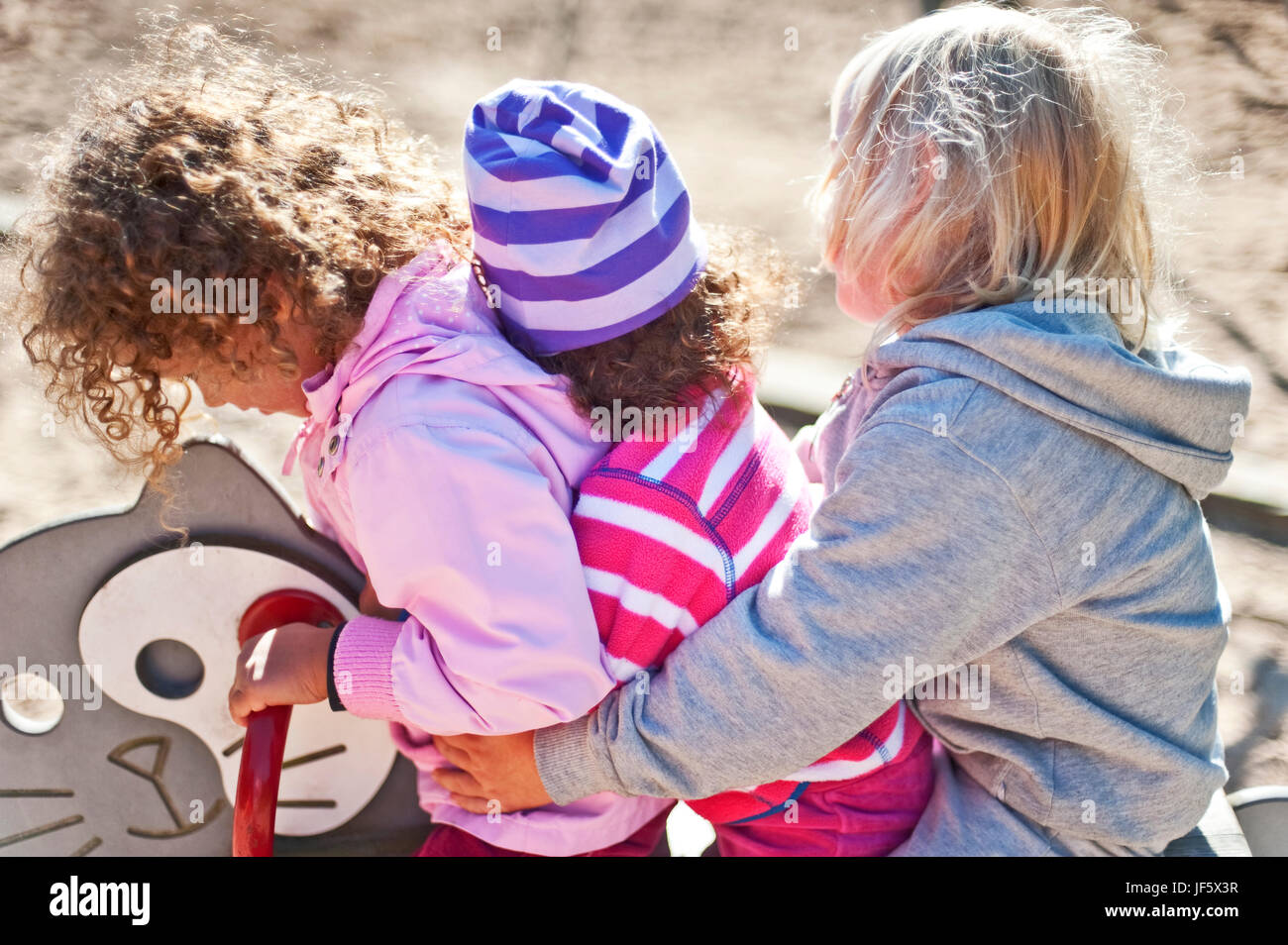 Three girls playing on playground Stock Photo - Alamy