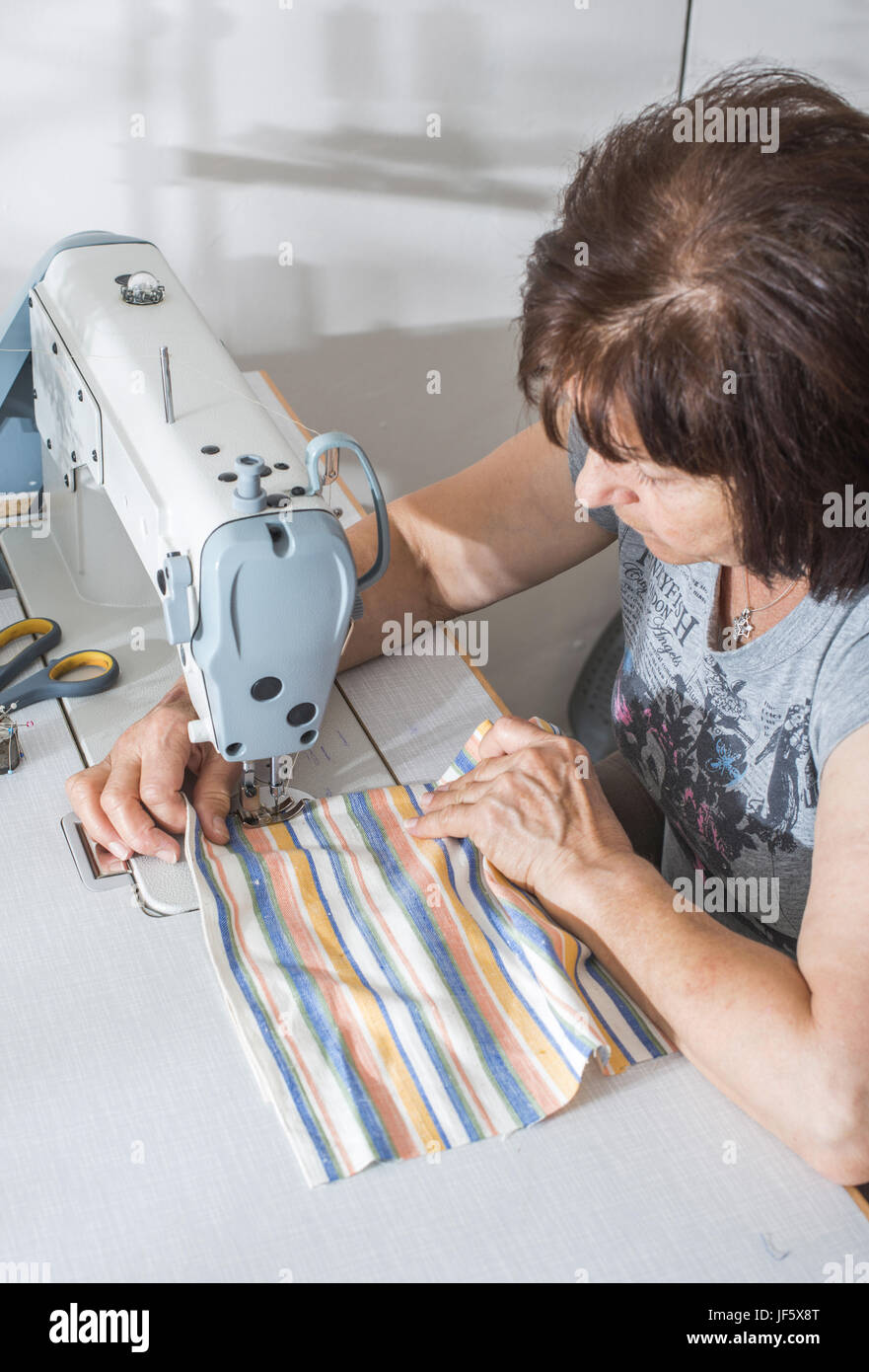 Women sew on sewing machine Stock Photo - Alamy