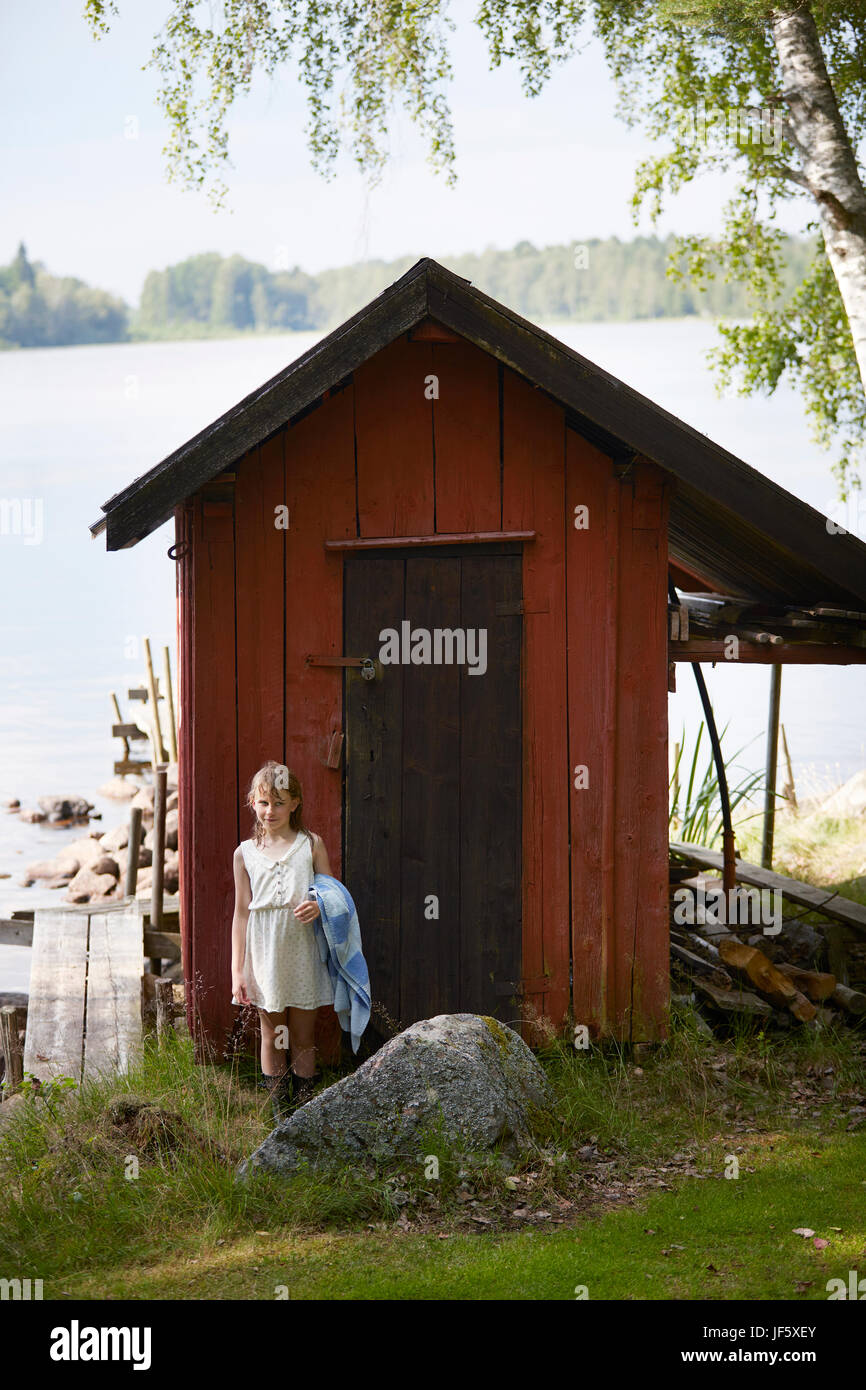 Girl in front of outhouse Stock Photo - Alamy