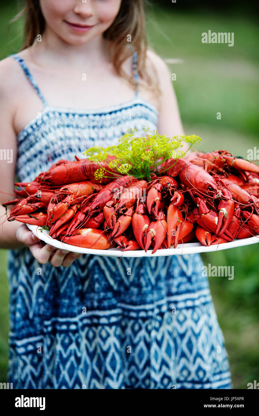 Girl holding tray with crayfish Stock Photo - Alamy