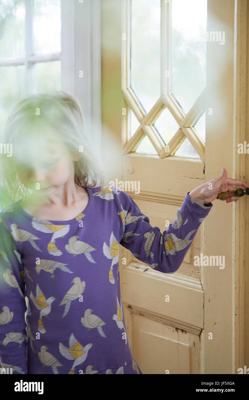 Girl opening door Stock Photo - Alamy