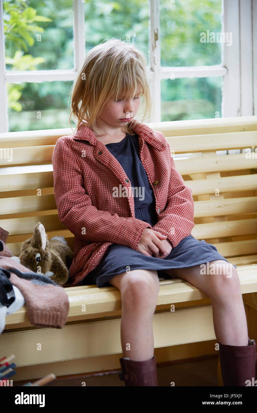 Sad girl sitting on bench Stock Photo - Alamy
