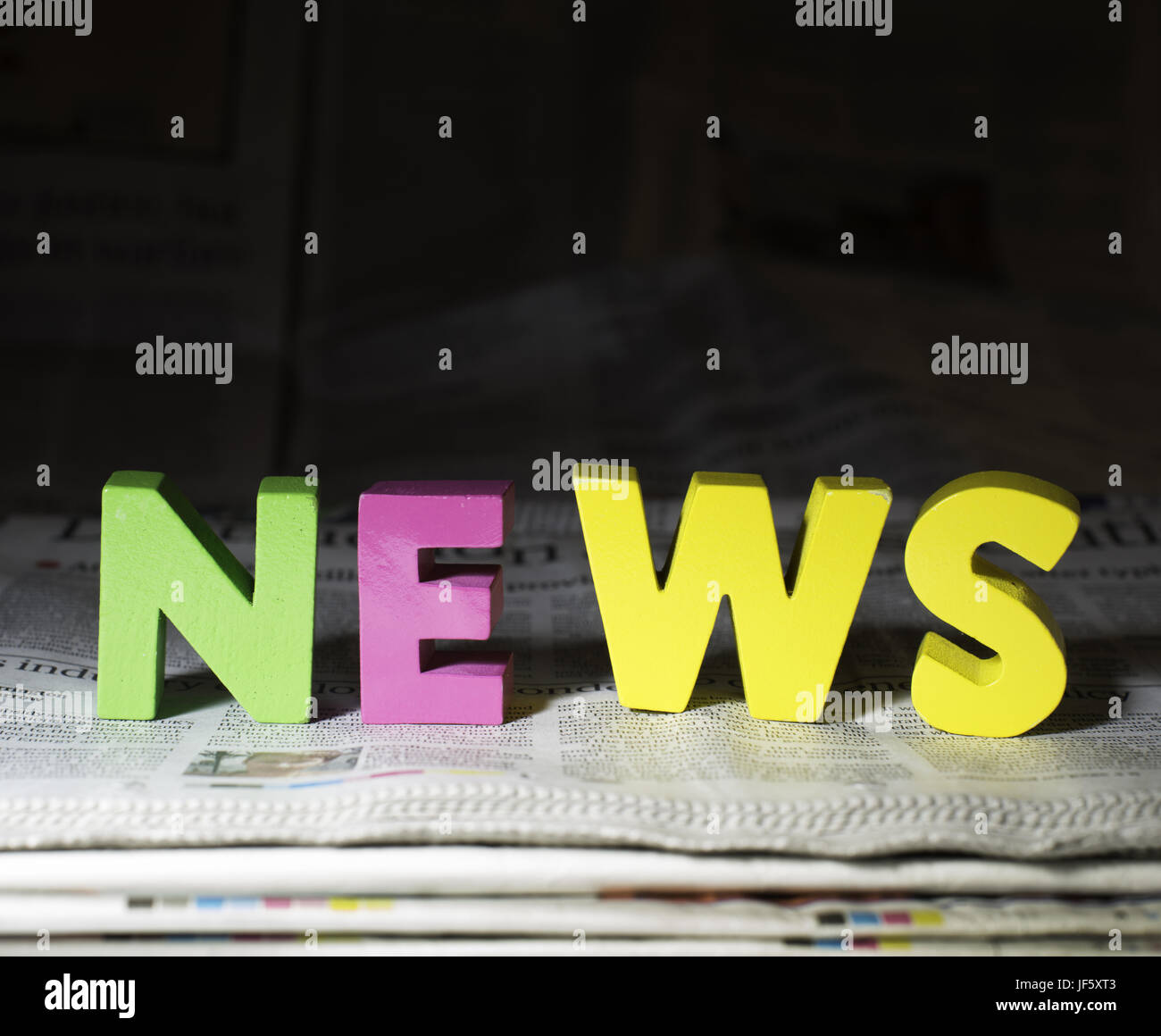 Word news on newspaper Stock Photo - Alamy