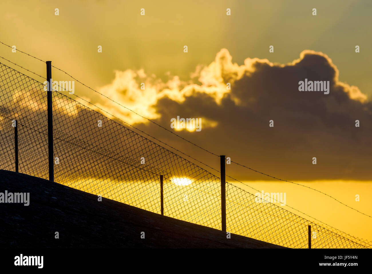Silhouette of fence at sunset Stock Photo - Alamy