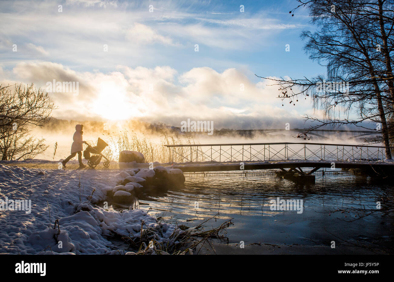 Woman with pram crossing footbridge Stock Photo - Alamy