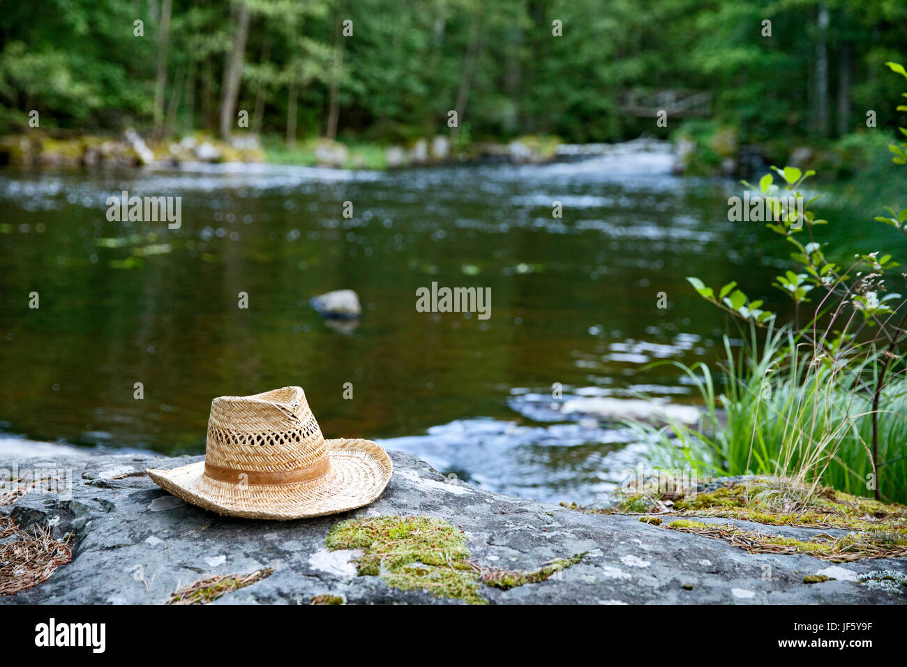 Straw hat at water Stock Photo - Alamy