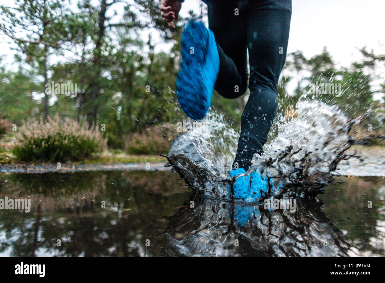 Person running through water Stock Photo - Alamy