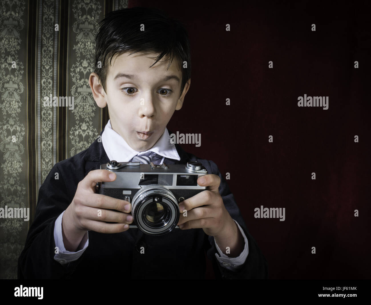 Child taking pictures with vintage camera Stock Photo - Alamy