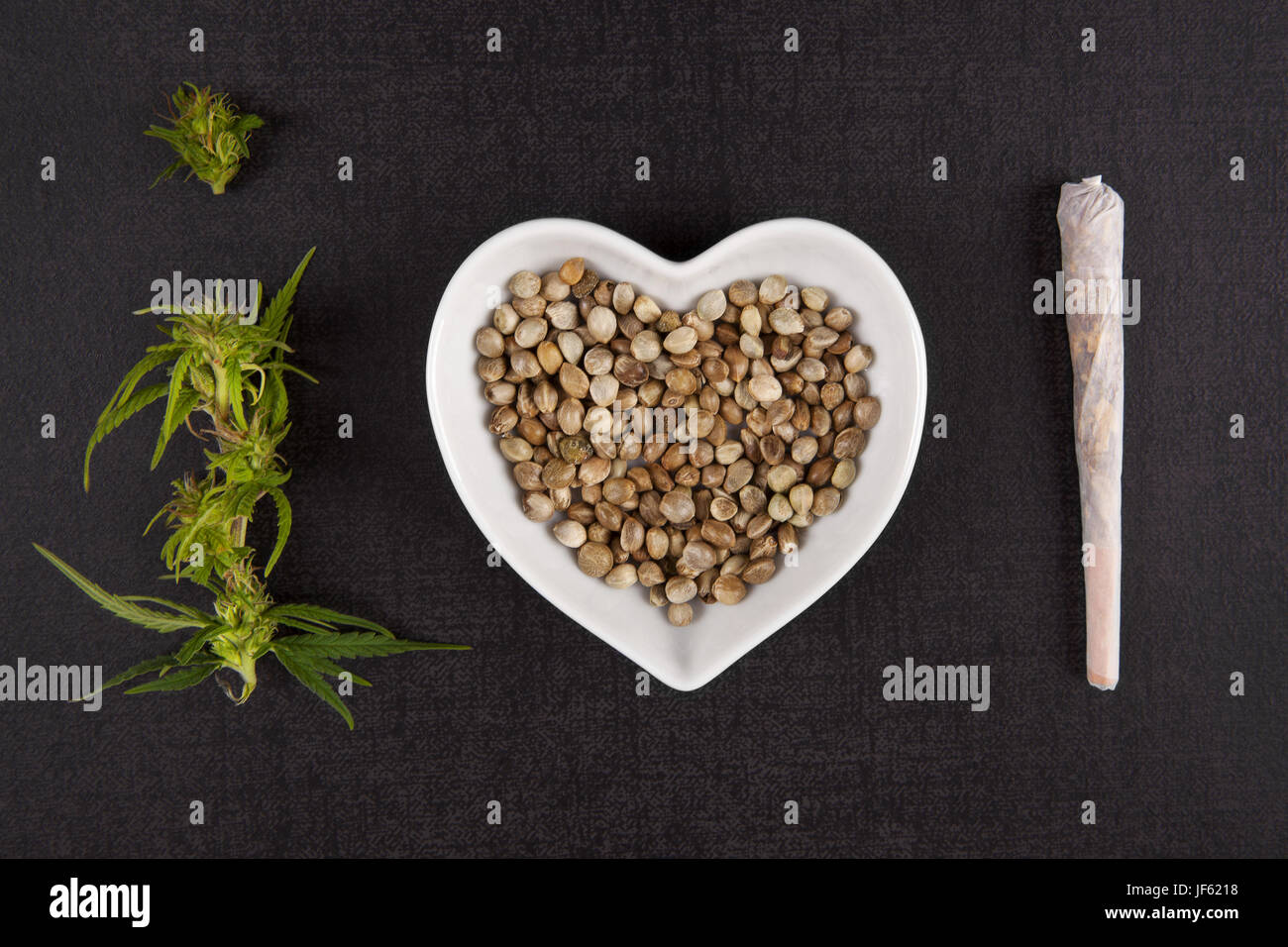 Healthy Marijuana medicine. Buds, seeds in heart shaped bowl and ...