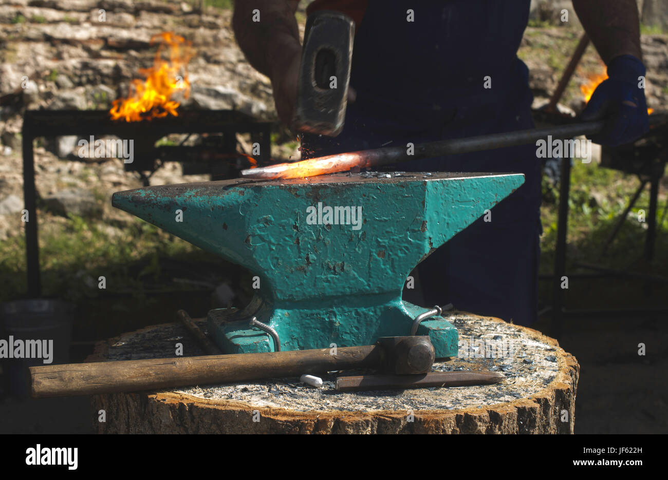 Blacksmith forges iron on anvil Stock Photo - Alamy