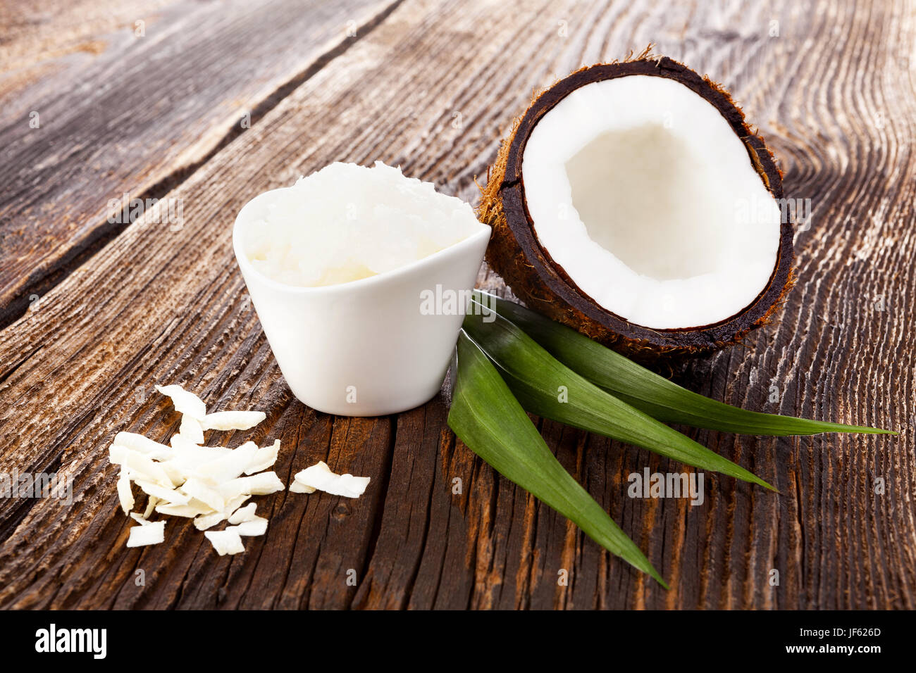 Shredded coconut with hard coconut oil. Fresh tasty coconut on dark ...