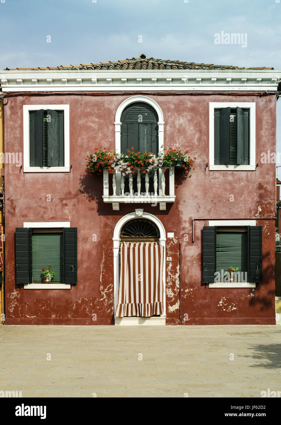 Bright red color house in Venice Stock Photo - Alamy