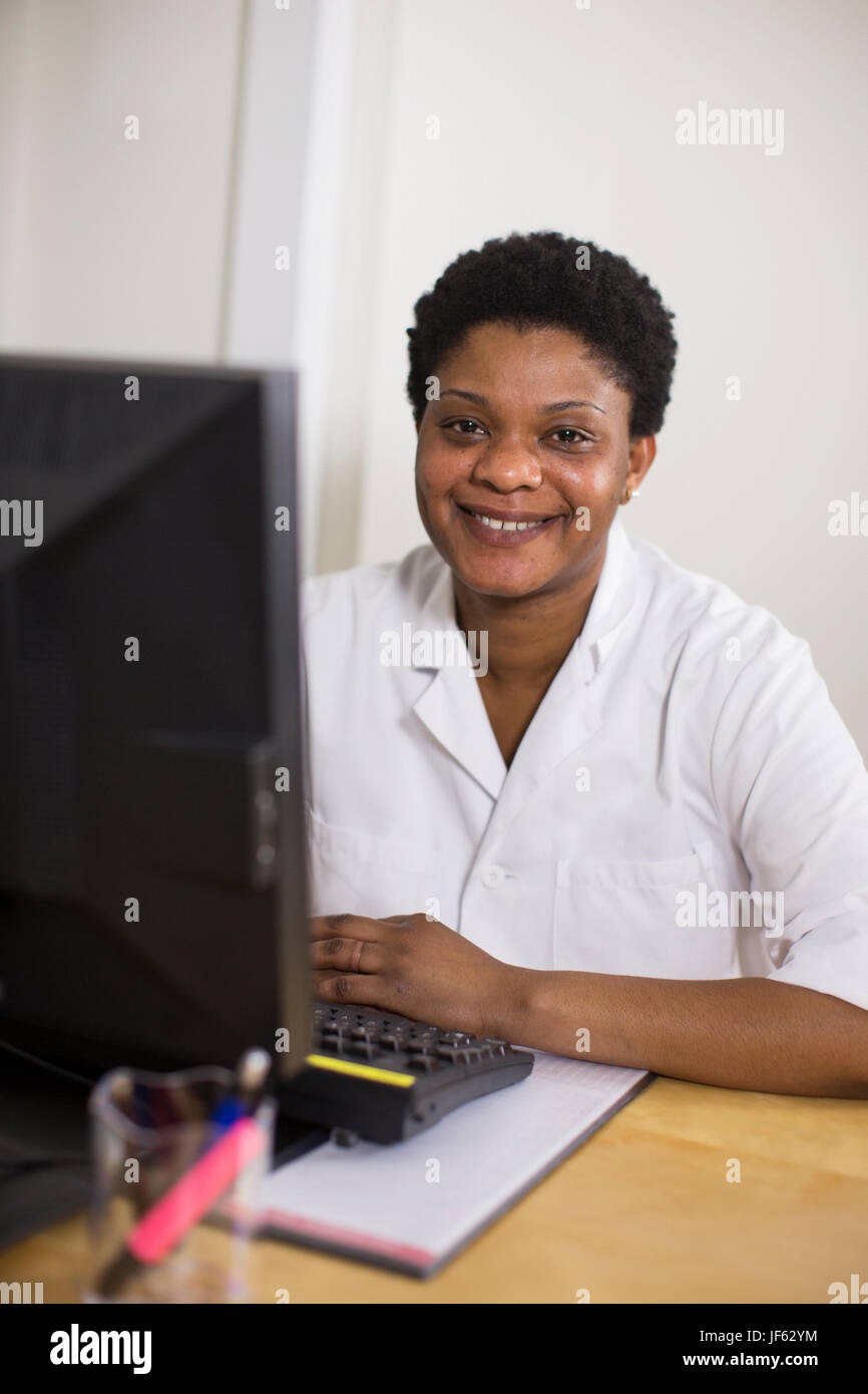 Smiling doctor using computer Stock Photo - Alamy