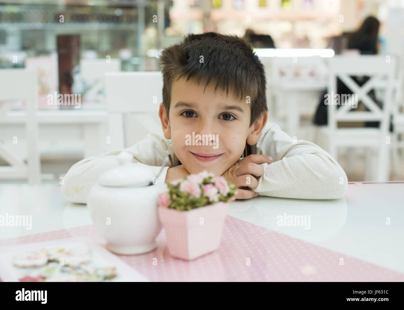 Child on table in confectionery Stock Photo - Alamy