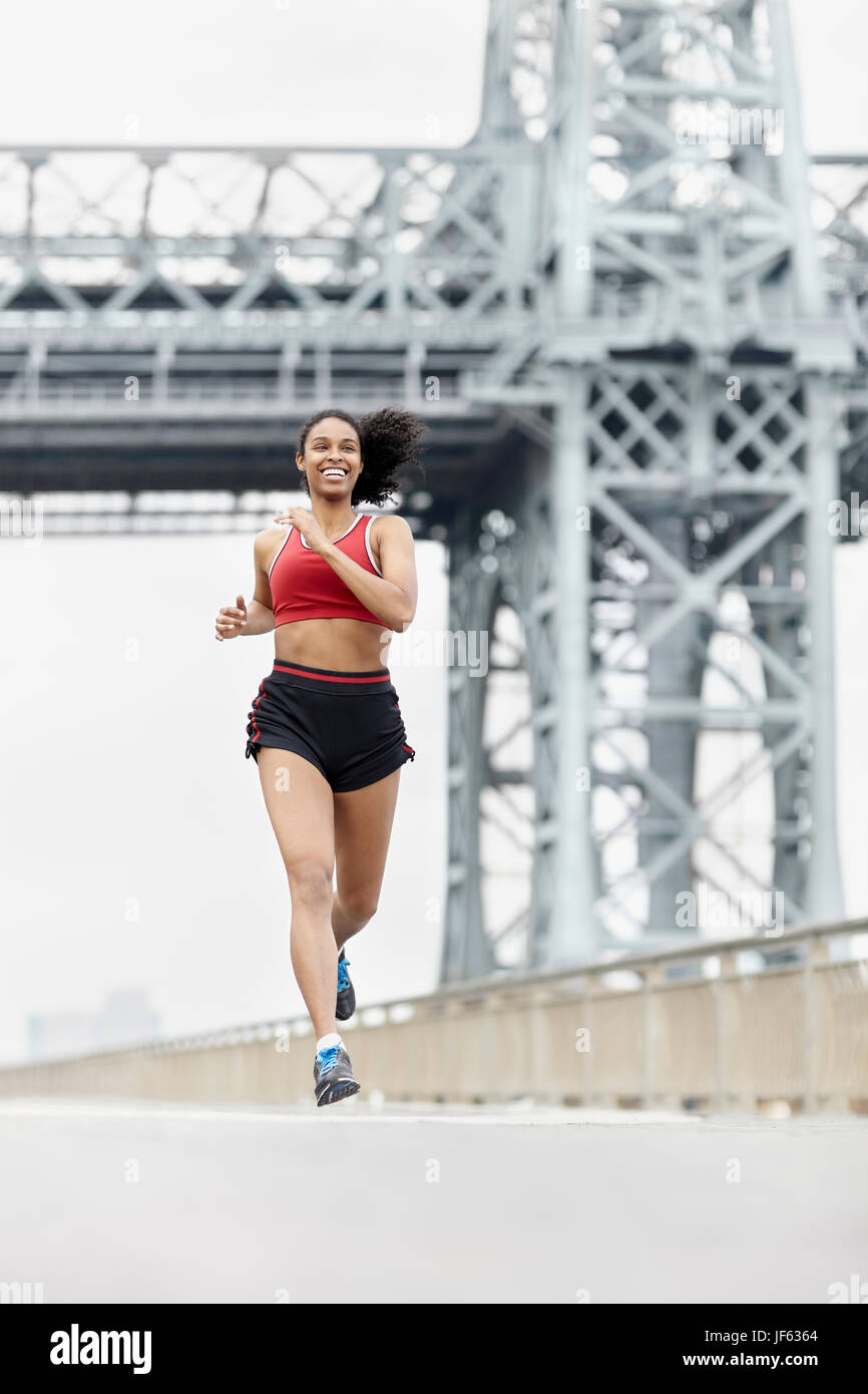 Brunette woman running on bridge hi-res stock photography and images ...