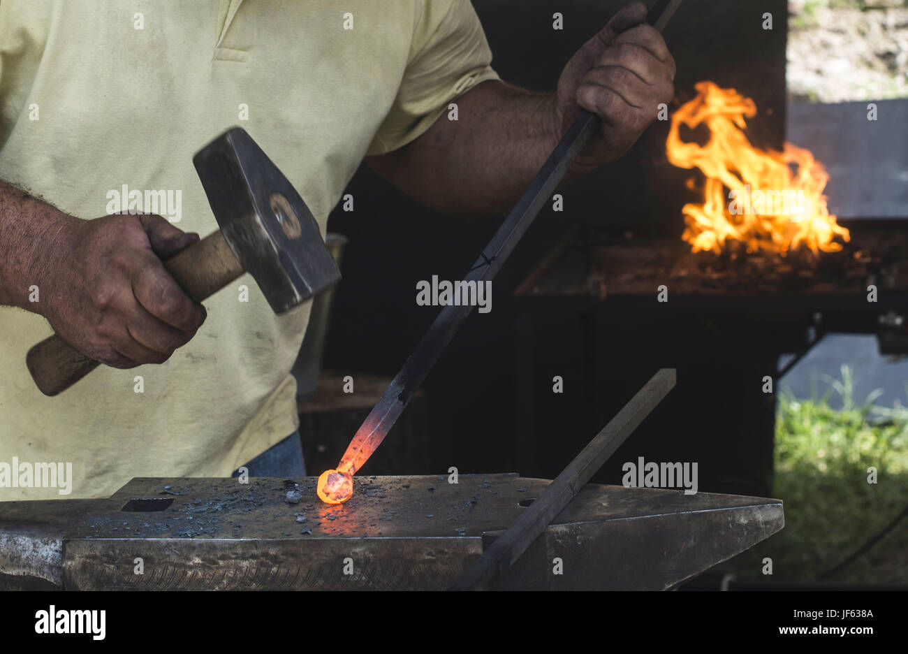 Blacksmith forges iron on anvil Stock Photo - Alamy