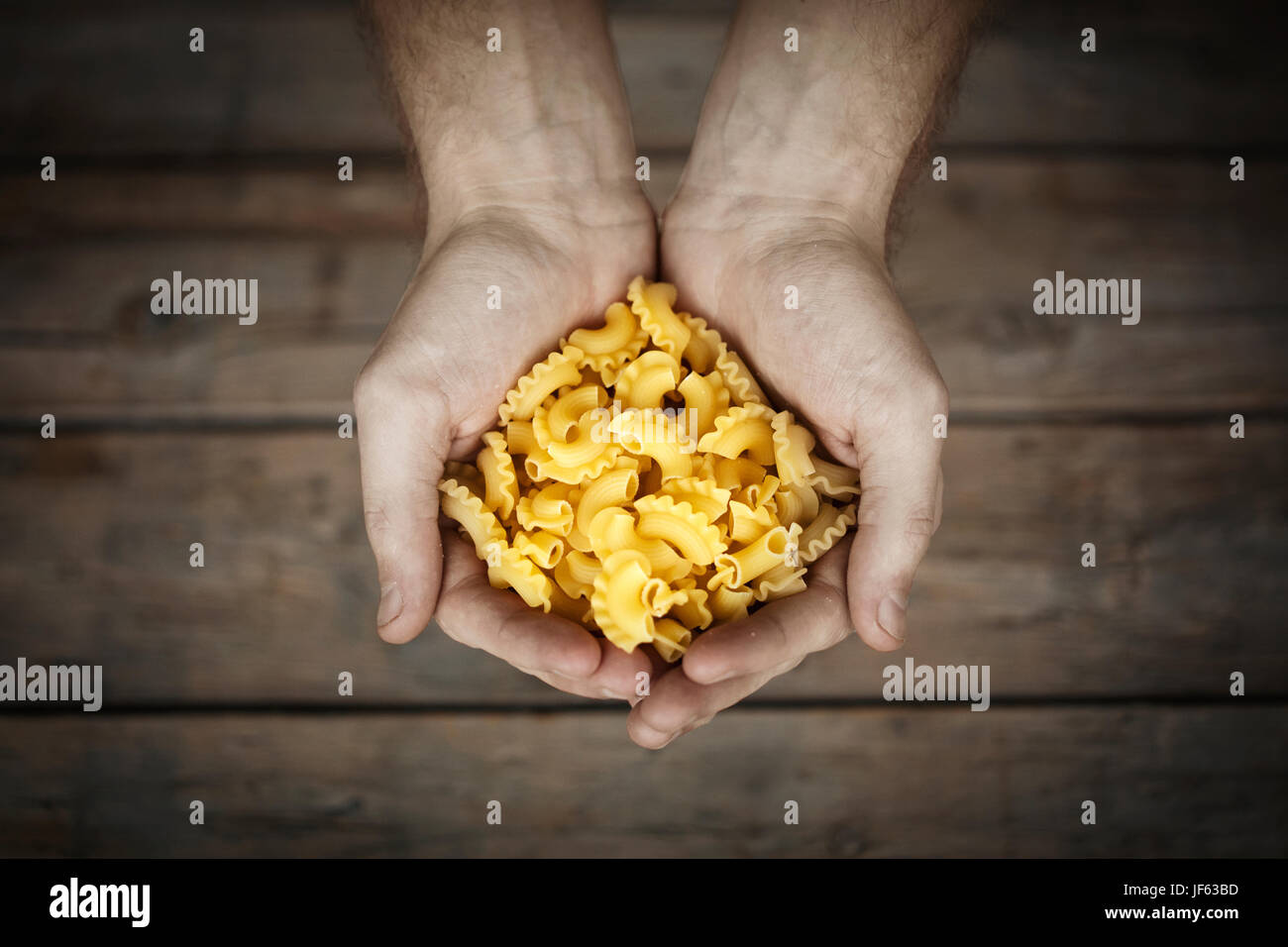 Pasta in mans hands, close-up Stock Photo - Alamy