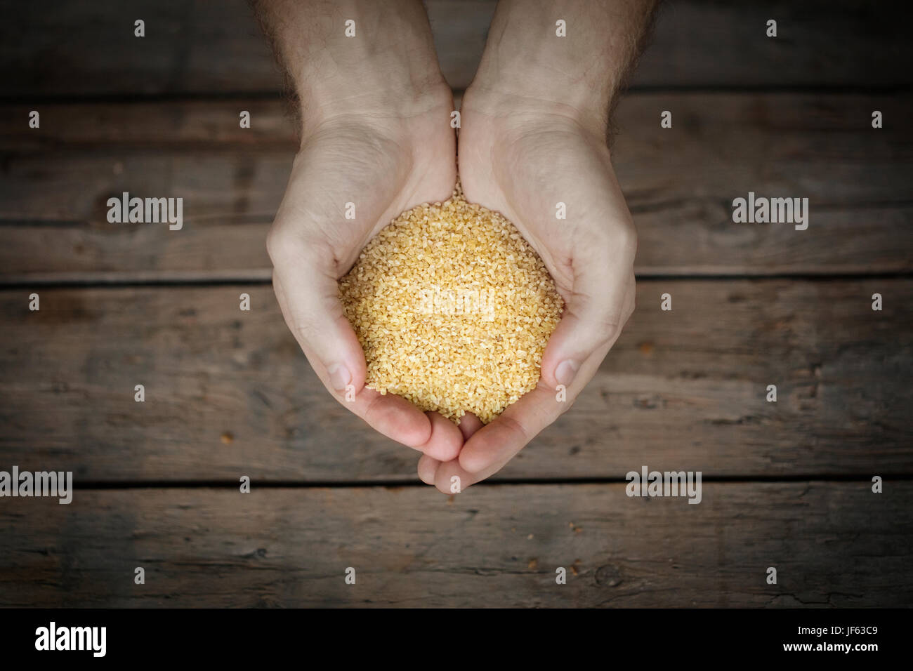 Millets in mans hands, close-up Stock Photo - Alamy
