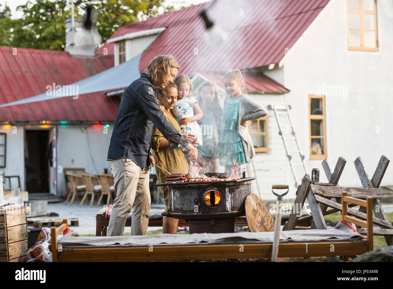Family having barbecue Stock Photo - Alamy