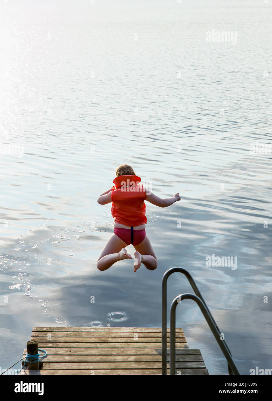 Child jumping into water Stock Photo - Alamy