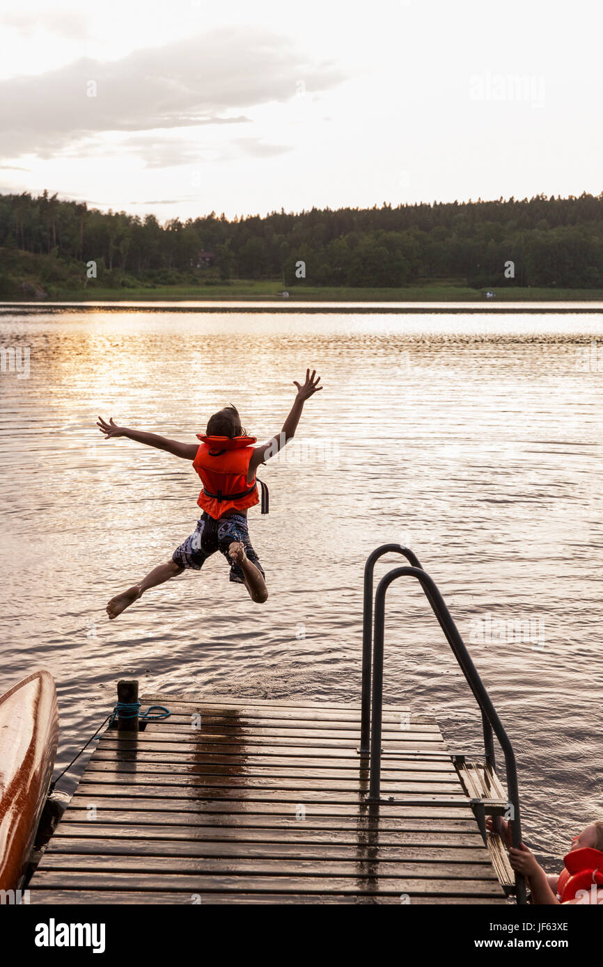 Child jumping into water Stock Photo - Alamy