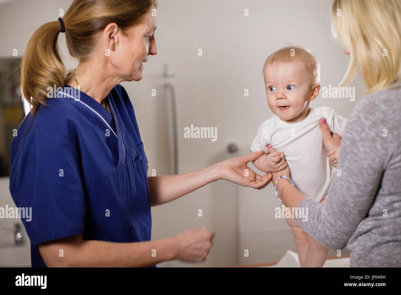Doctor checking baby Stock Photo - Alamy
