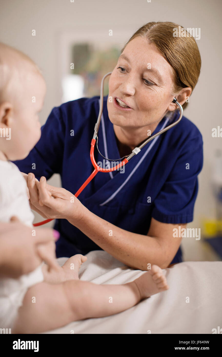 Doctor checking baby Stock Photo - Alamy