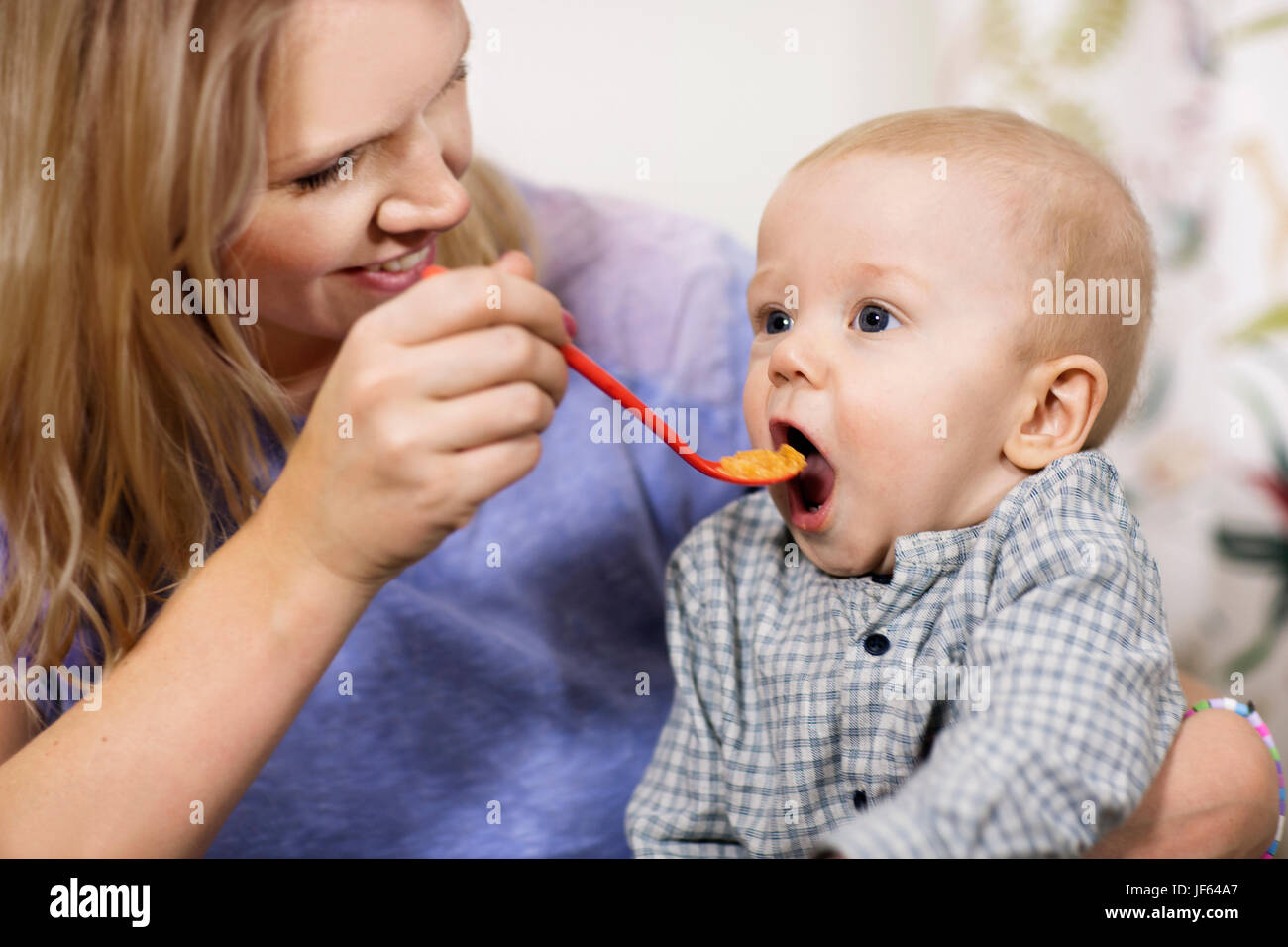 Mother feeding baby boy Stock Photo - Alamy