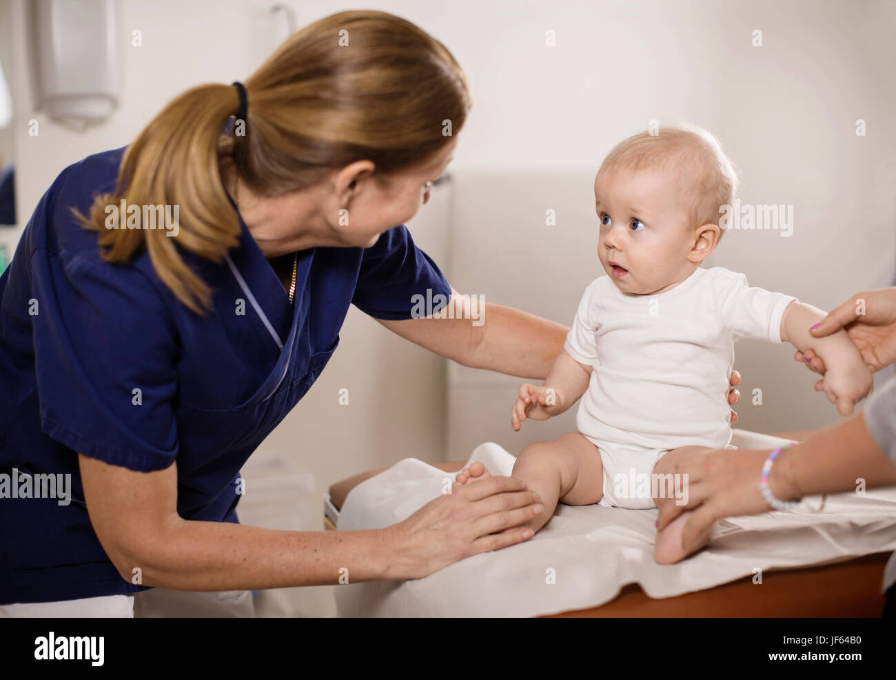 Doctor checking baby Stock Photo - Alamy