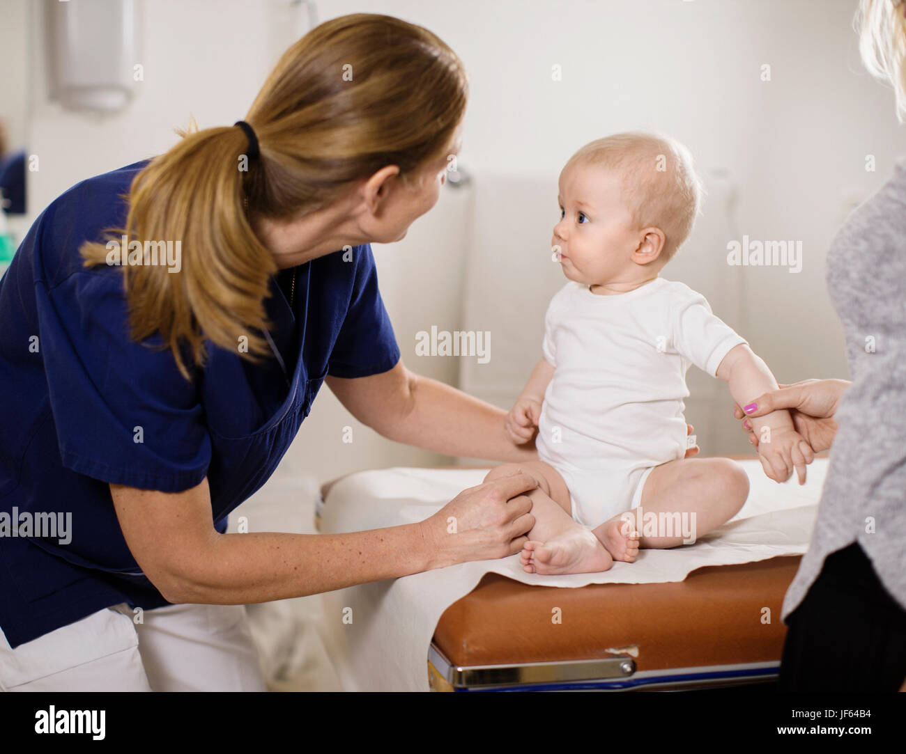 Doctor checking baby Stock Photo - Alamy