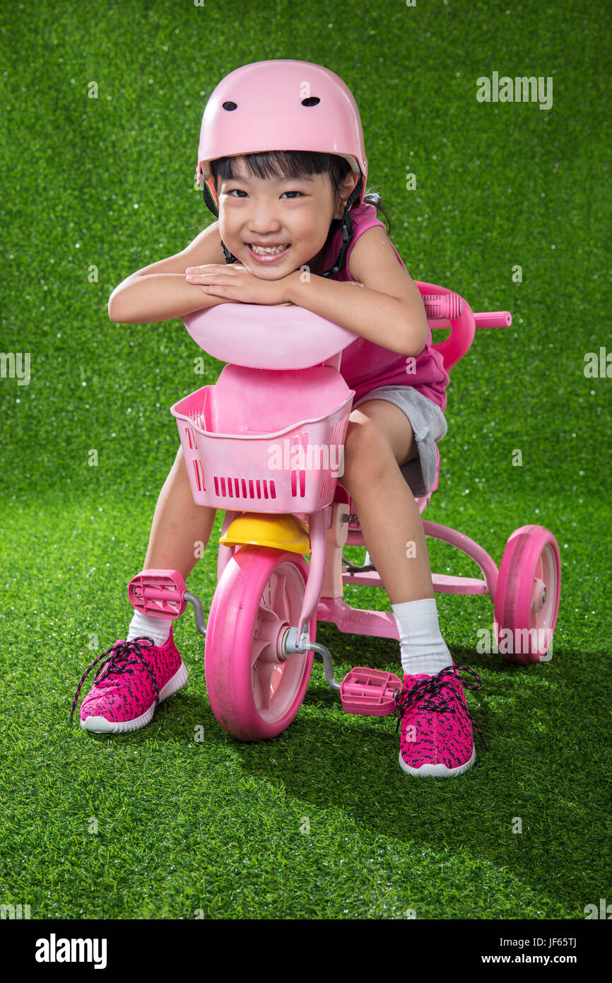Asian Chinese little girl riding bicycle at outdoor park Stock Photo ...