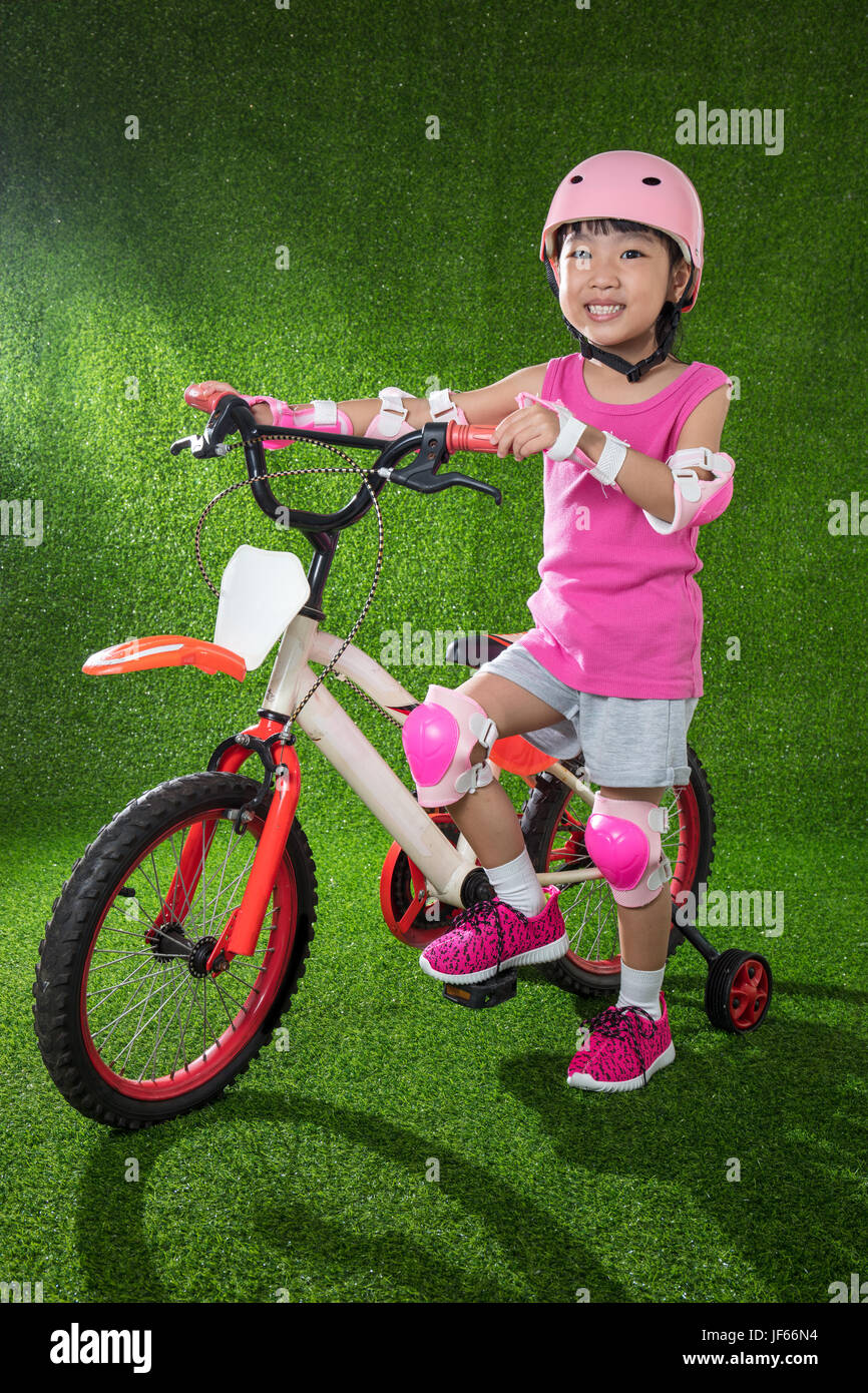 Asian Chinese little girl riding bicycle at outdoor park Stock Photo ...