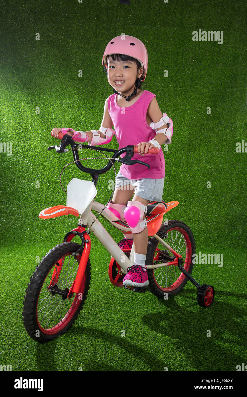 Asian Chinese little girl riding bicycle at outdoor park Stock Photo ...