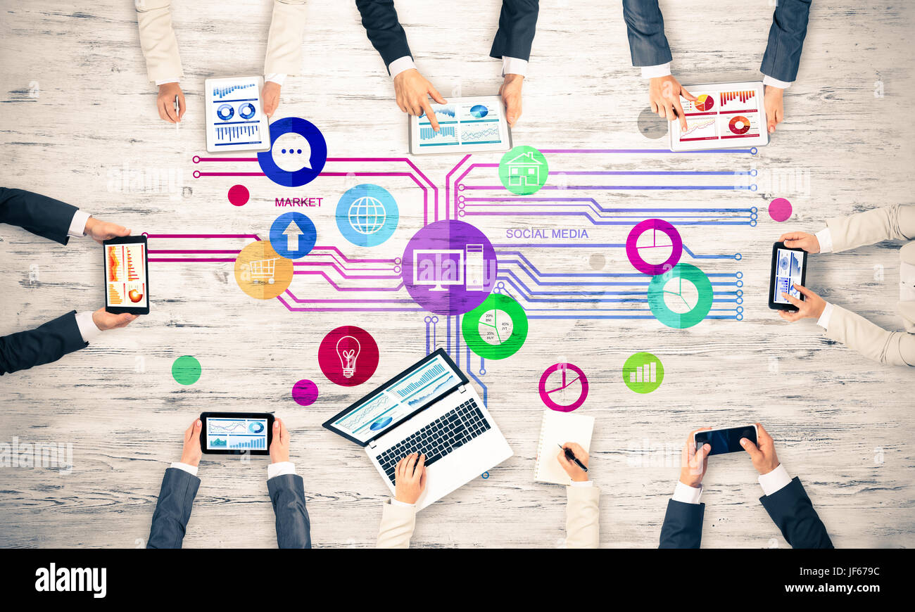 Group of people with devices in hands working together as symbol of ...