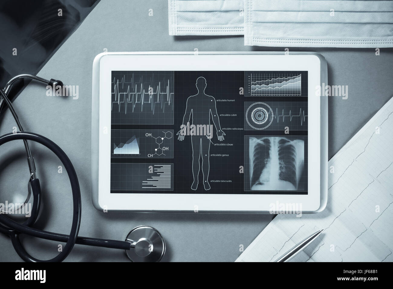 White tablet pc and doctor tools on gray surface Stock Photo - Alamy