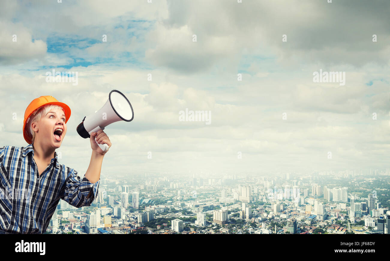 Engineer woman with megaphone on modern city landscape Stock Photo - Alamy