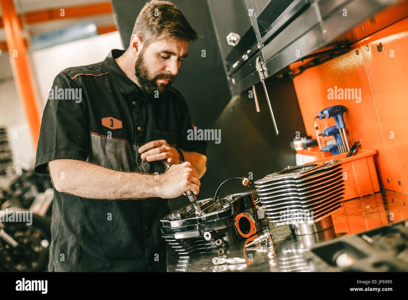Motorcycle mechanic engine repair at service station. Motorcycle engine ...