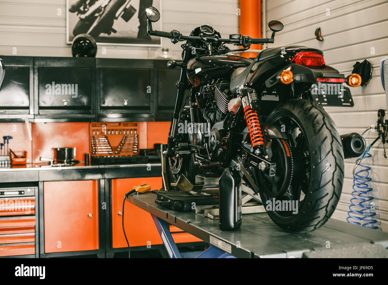 A sports motorcycle at a service station. The bike is on the lift ...