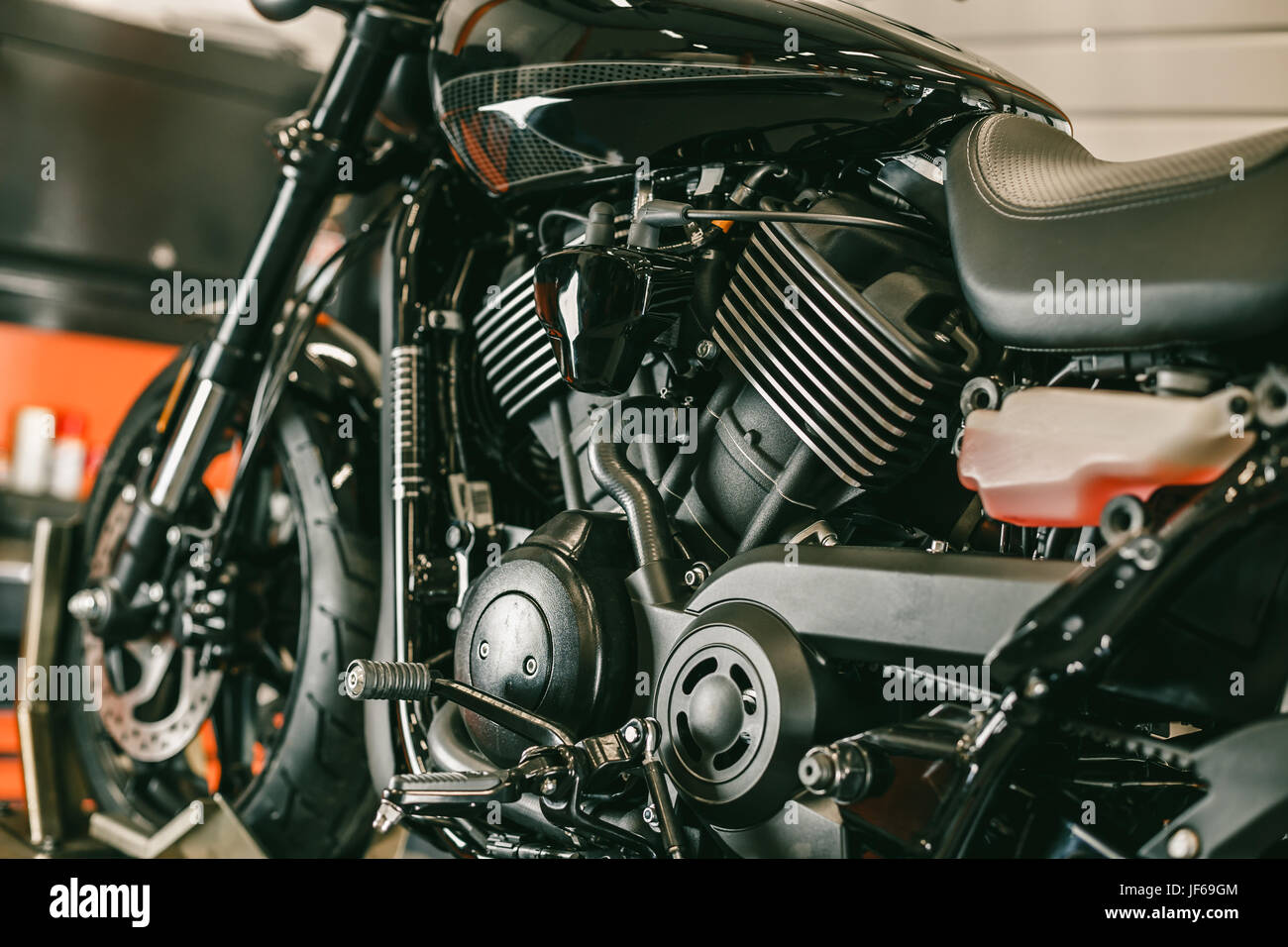 Close up side view of the motorcycle on the lift at the service station ...