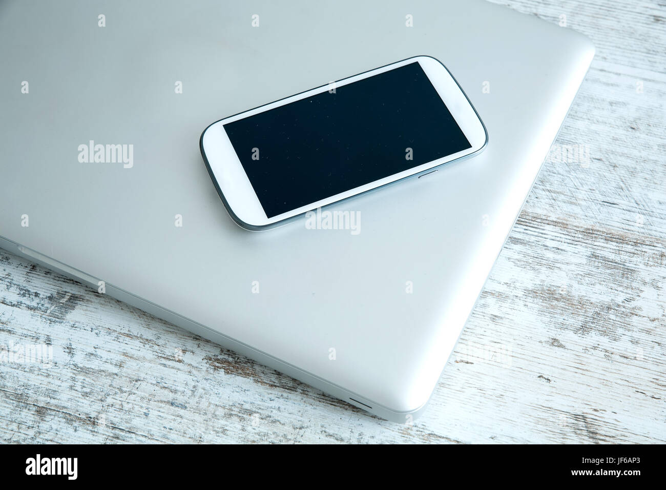 Smartphone and a laptop computer Stock Photo - Alamy