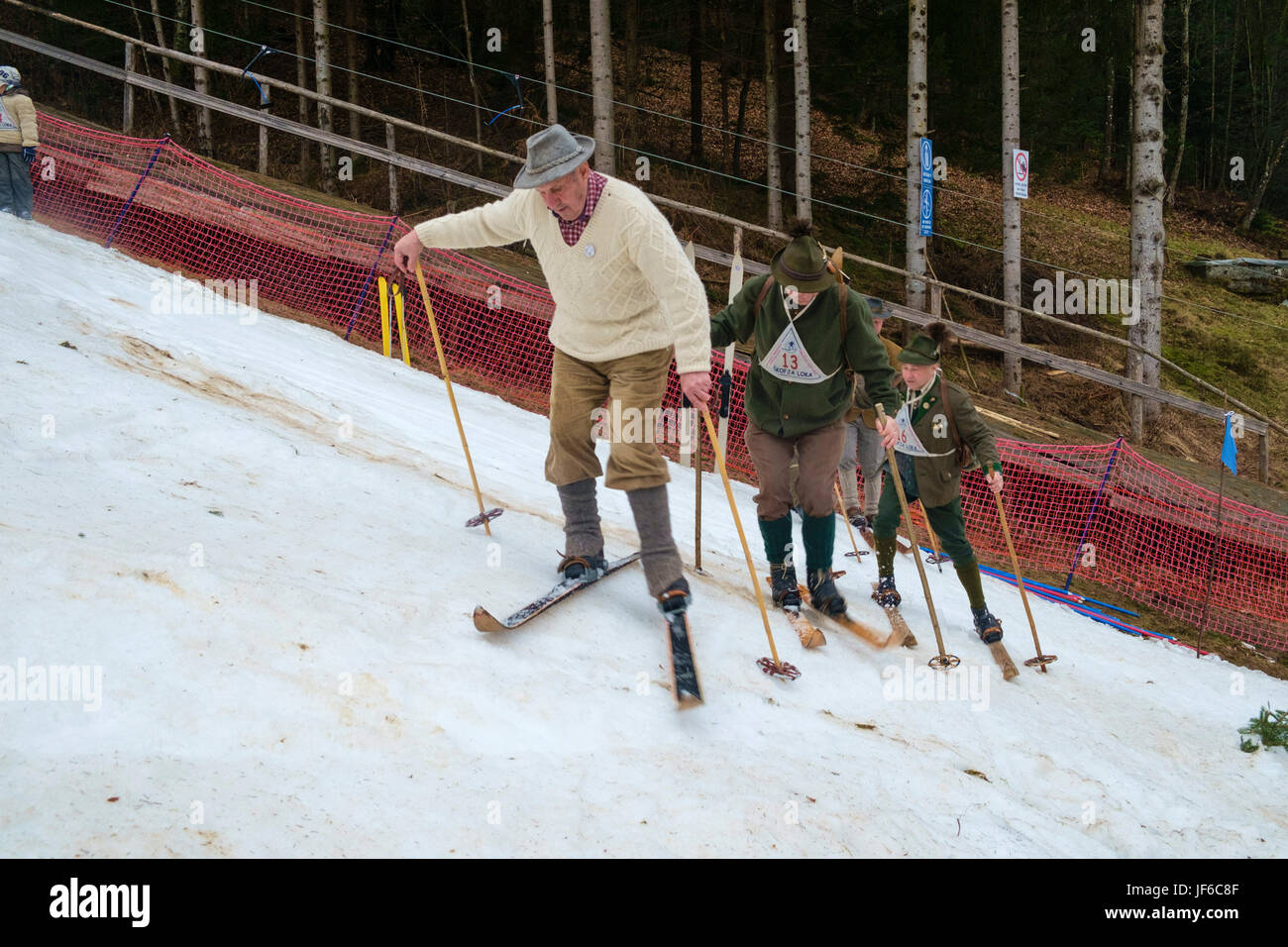 Skiers in traditional retro style costumes, with old wooden ski gear at ...