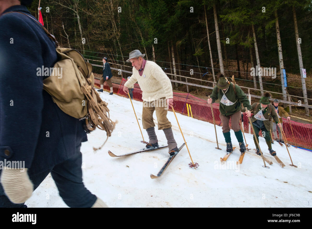 Skiers in traditional retro style costumes, with old wooden ski gear at ...