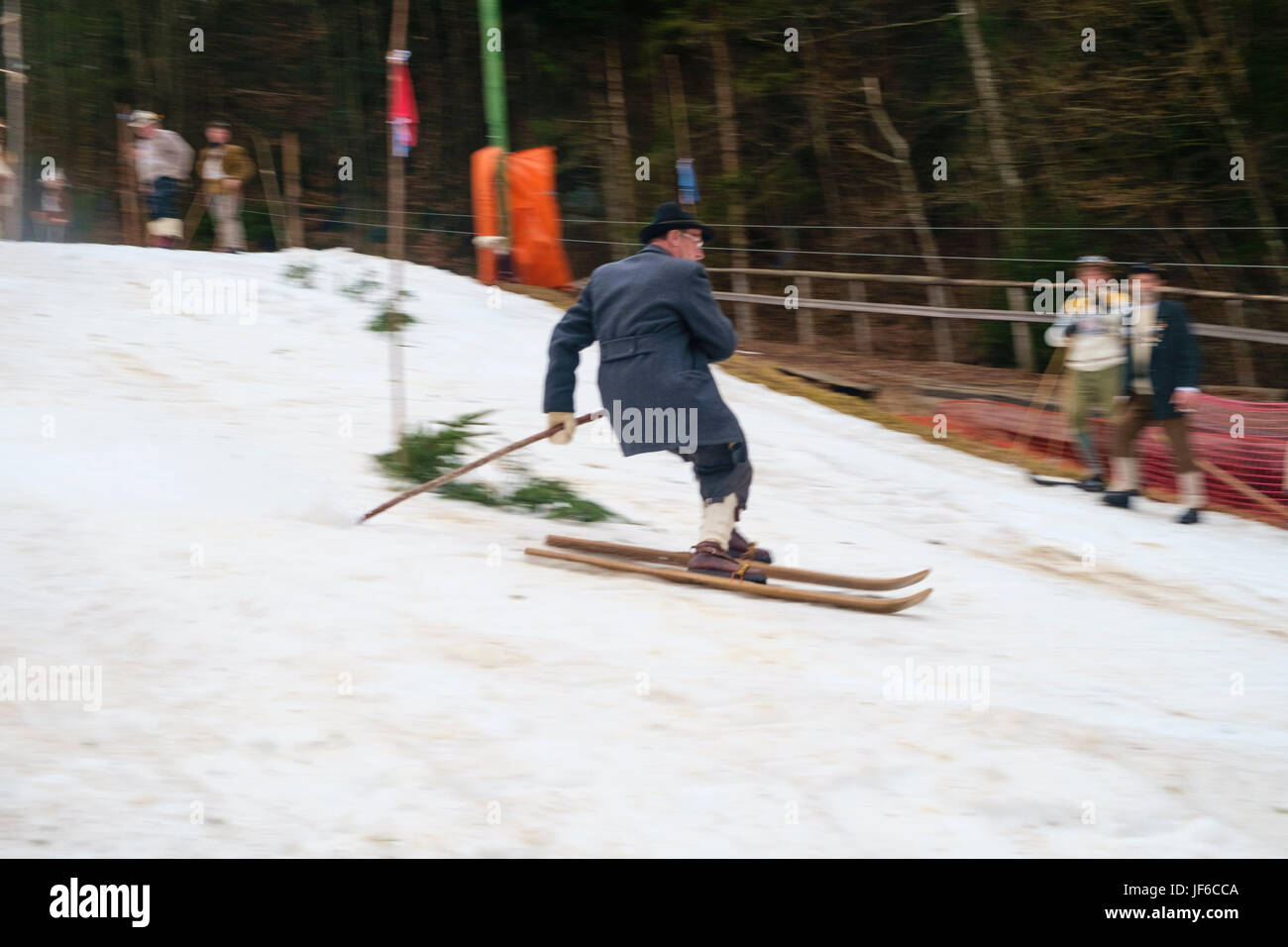 Skiers in traditional retro style costumes, with old wooden ski gear at ...