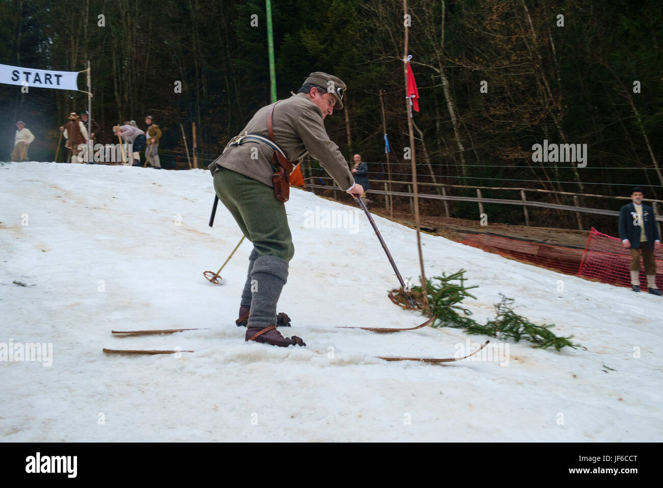 Skiers in traditional retro style costumes, with old wooden ski gear at ...