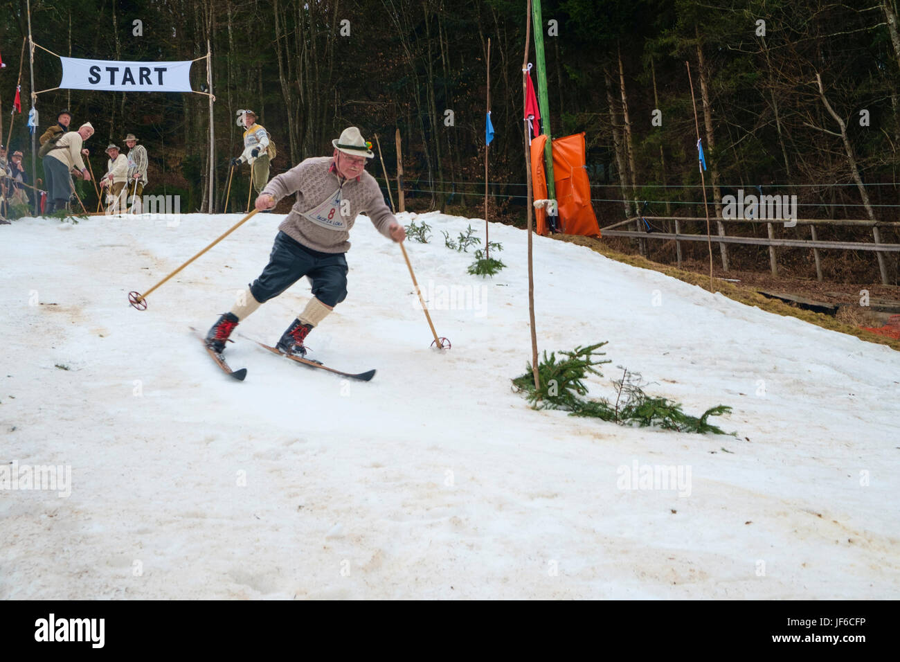 Skiers in traditional retro style costumes, with old wooden ski gear at ...