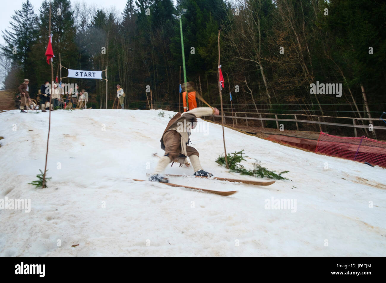 Skiers in traditional retro style costumes, with old wooden ski gear at ...